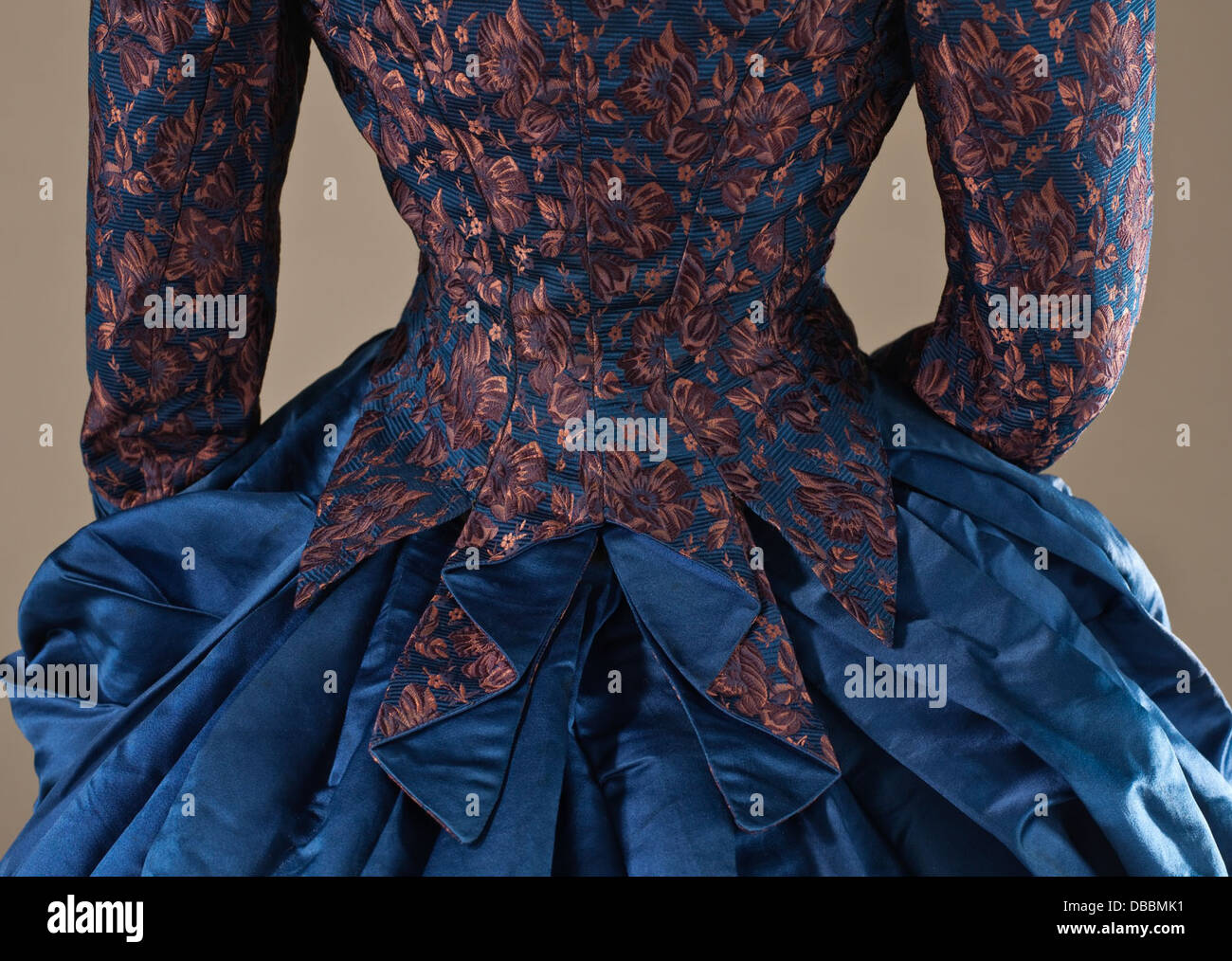 This woman's dress showcases traditional textile art, featuring ...