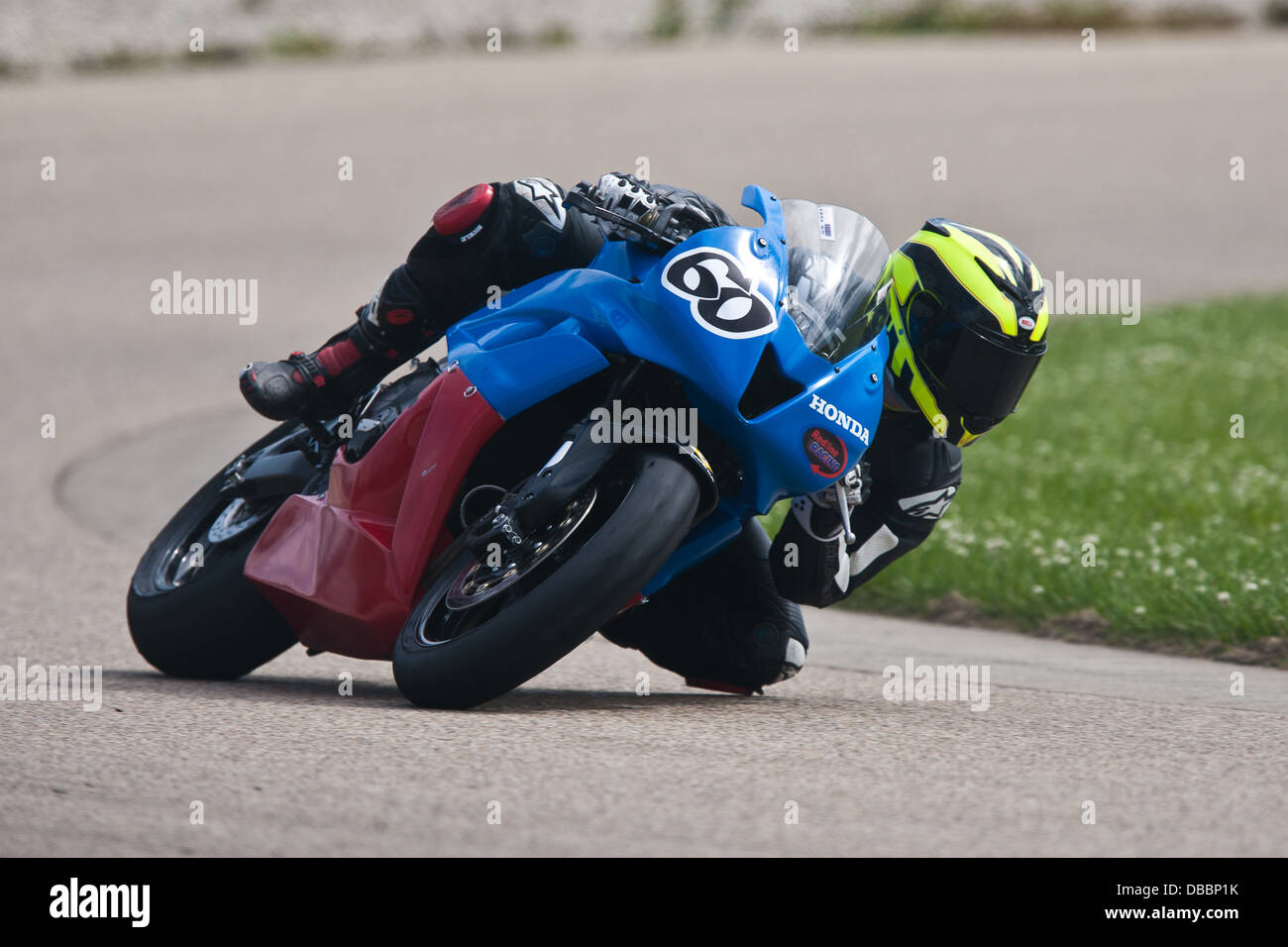 Motorcycle racer on track in left turn Stock Photo - Alamy