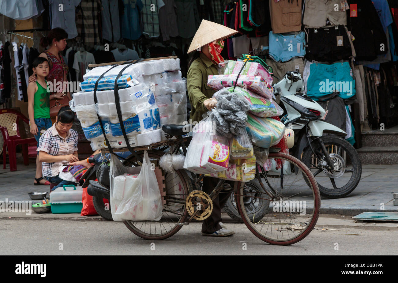 A street vendor selling fresh produce from her bicycle in Hanoi ...