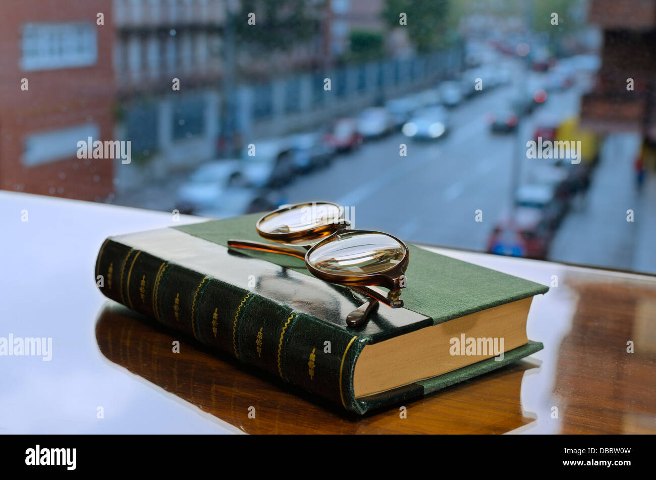 glasses on the book front of the window Stock Photo - Alamy
