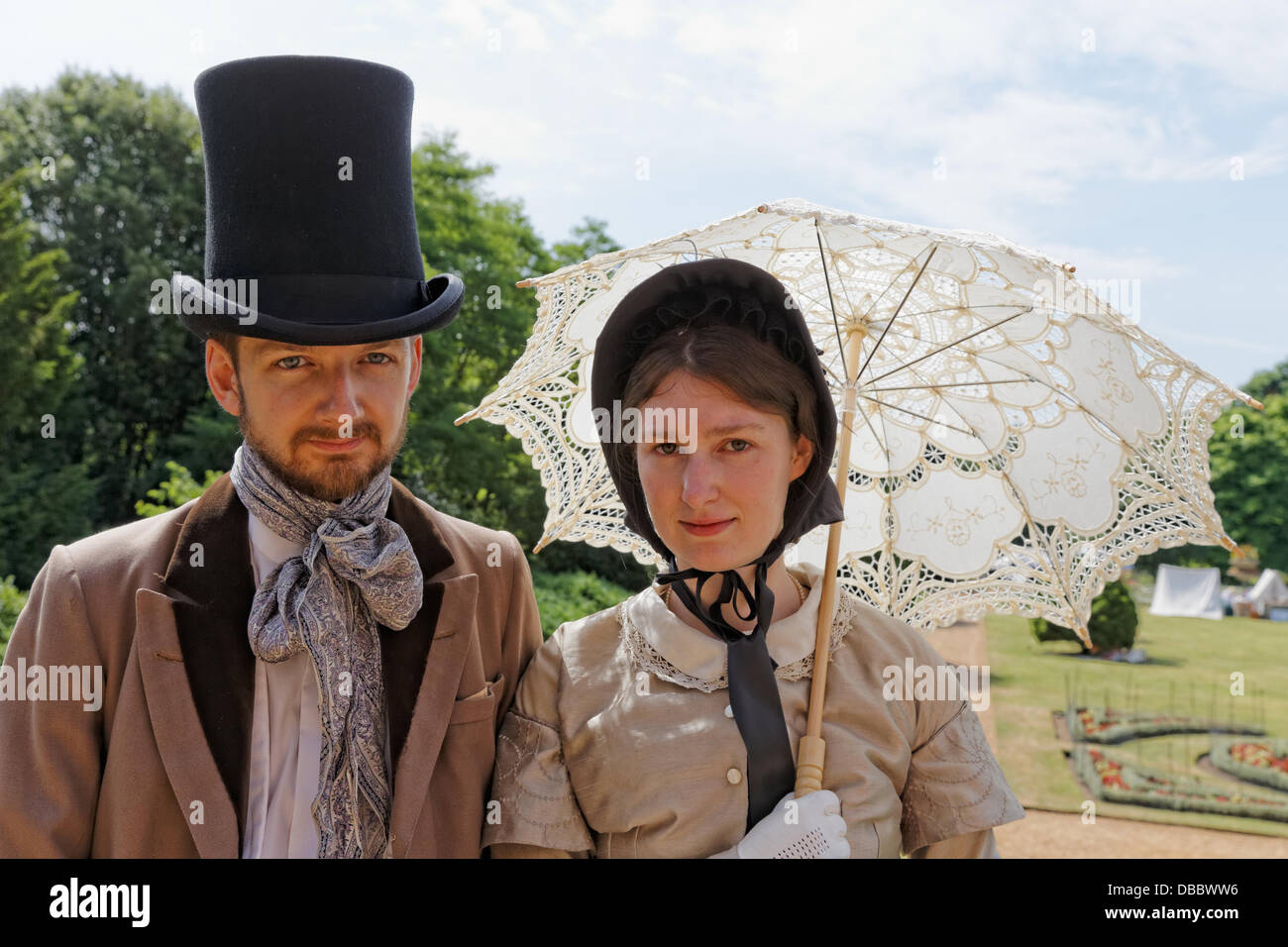Victorian era recreation: A top hatted gentleman and lady with parasol ...
