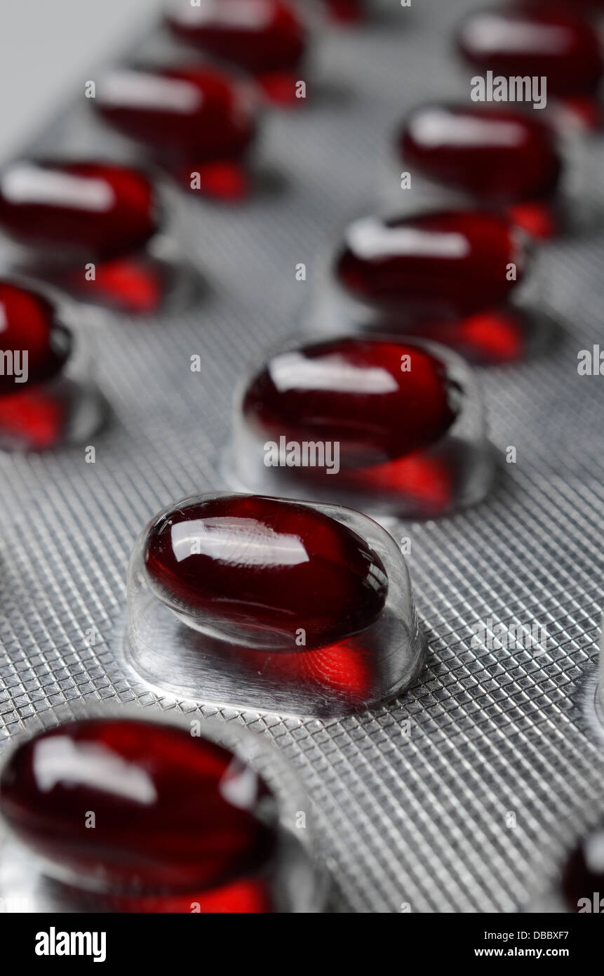 Closeup of red capsules Stock Photo - Alamy