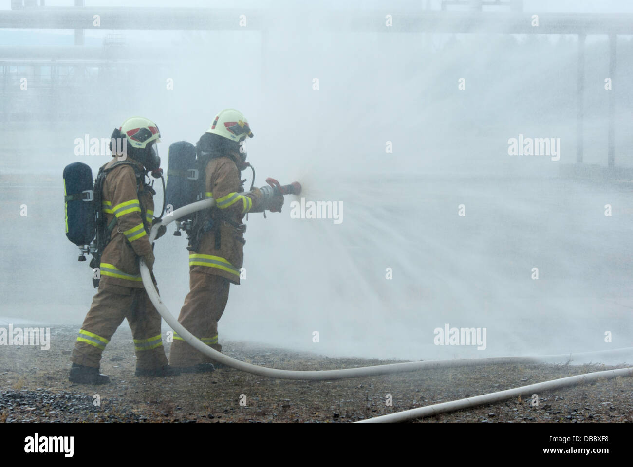 Firemans in action Stock Photo - Alamy