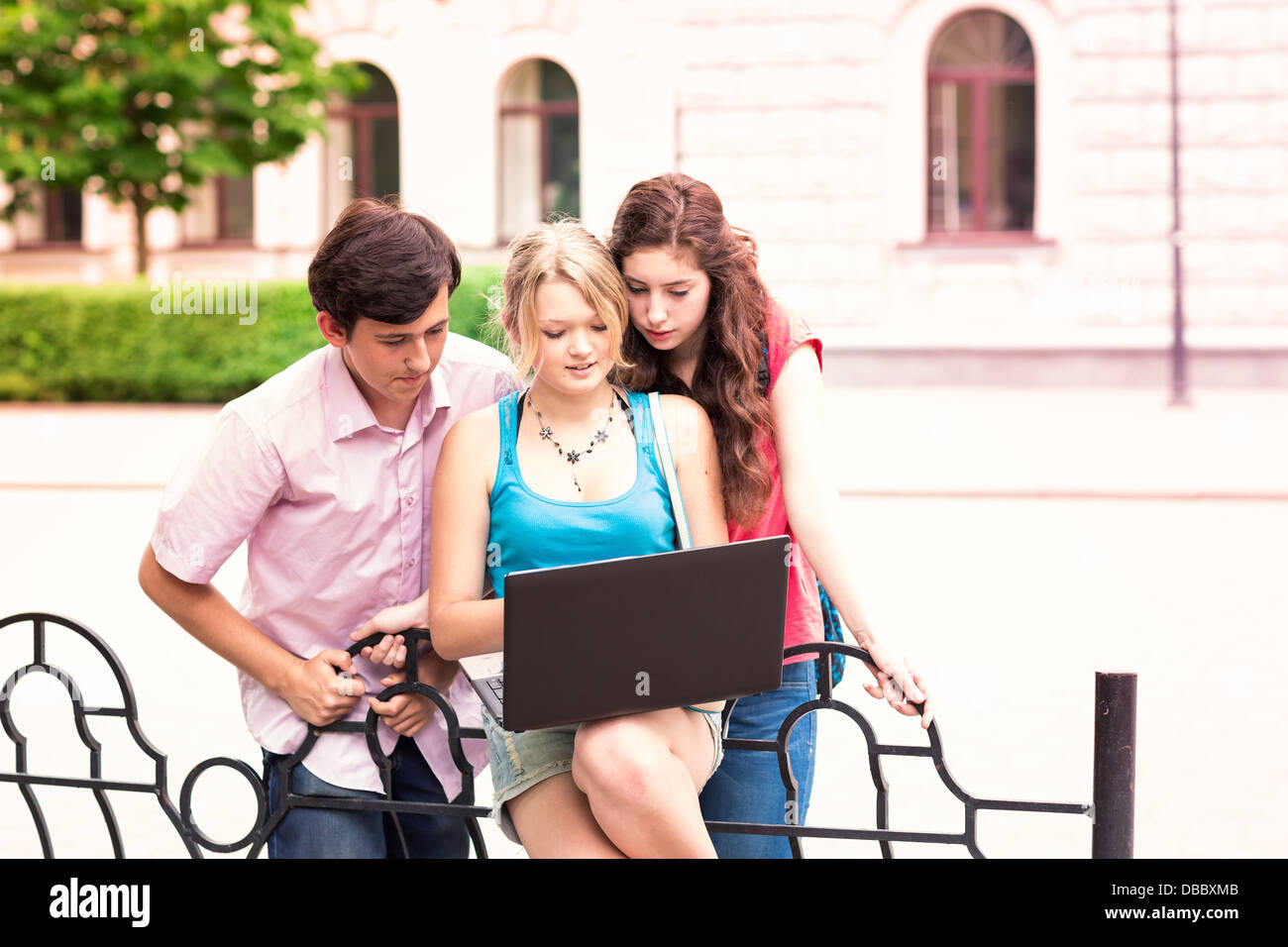 Group of happy smiling Teenage Students looking in laptop Stock Photo ...