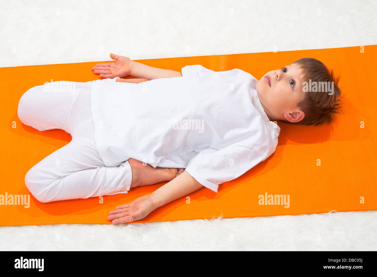 Children's yoga. The little boy does exercise Stock Photo - Alamy