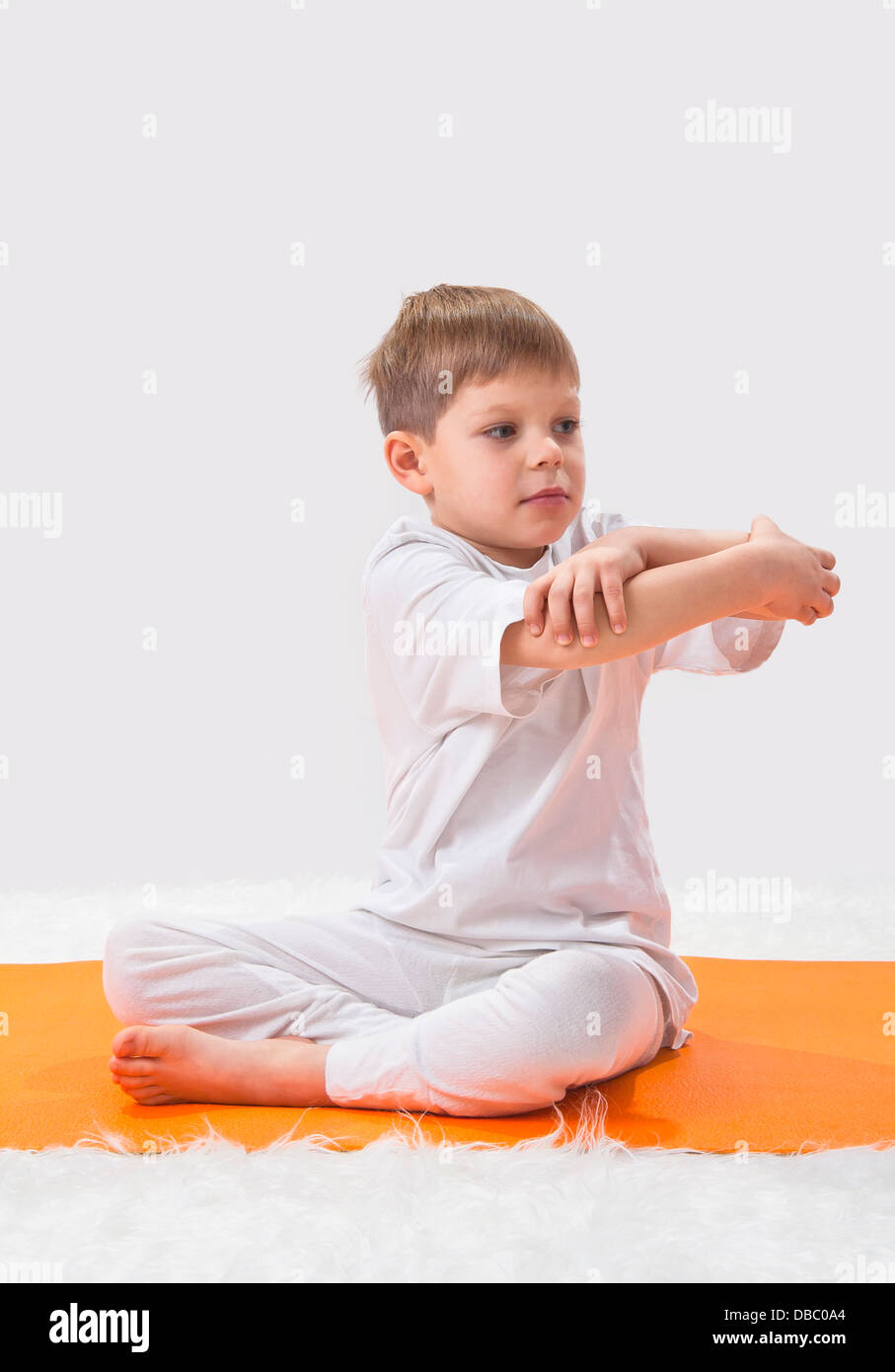 Children's yoga. The little boy does exercise Stock Photo - Alamy