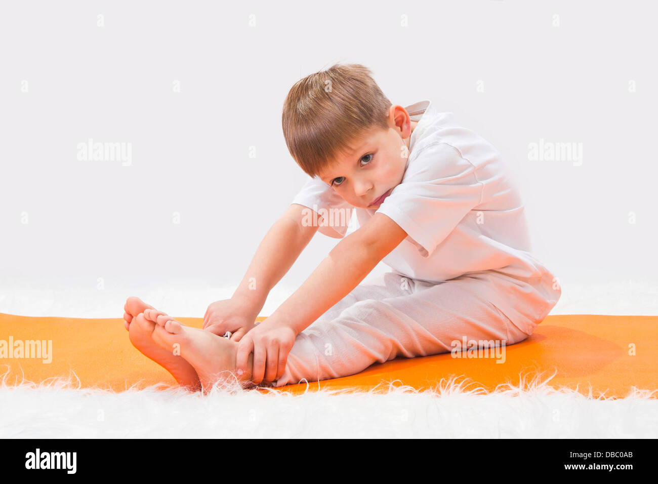 Children's yoga. The little boy does exercise Stock Photo - Alamy
