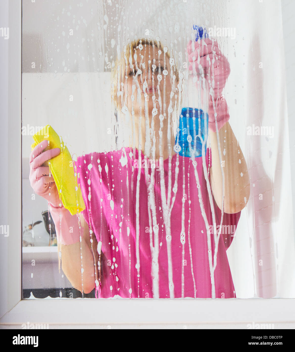 Young woman washing the window glass Stock Photo - Alamy