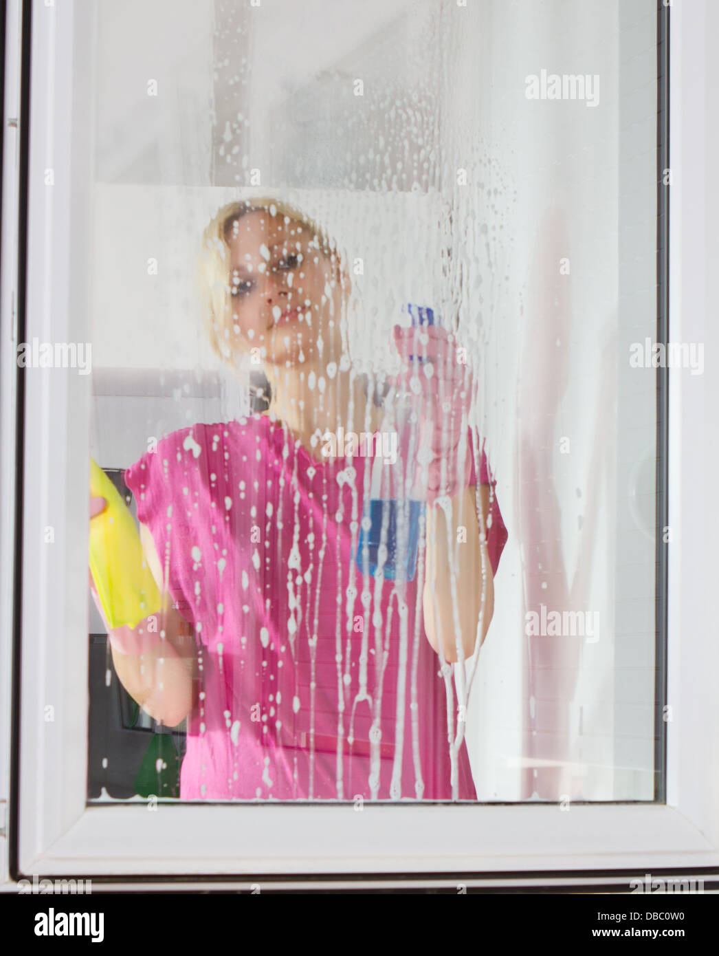 Young woman washing the window glass Stock Photo - Alamy