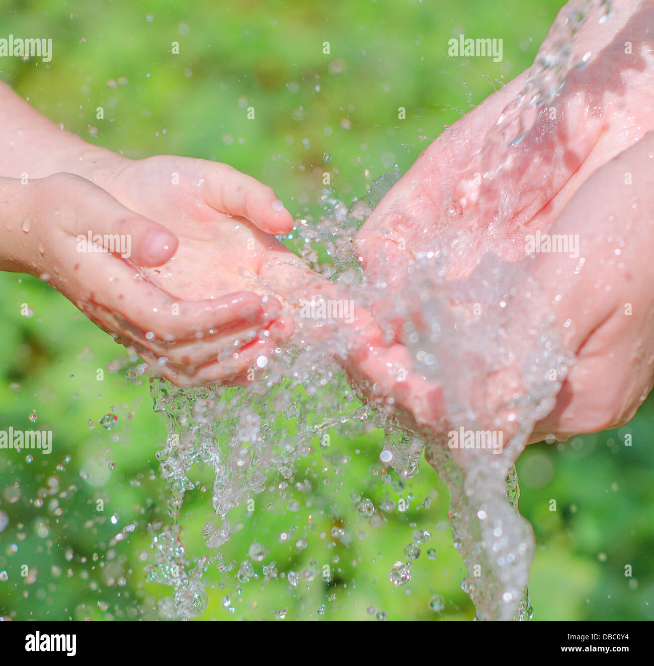 Child's and woman's hands playing with water Stock Photo - Alamy