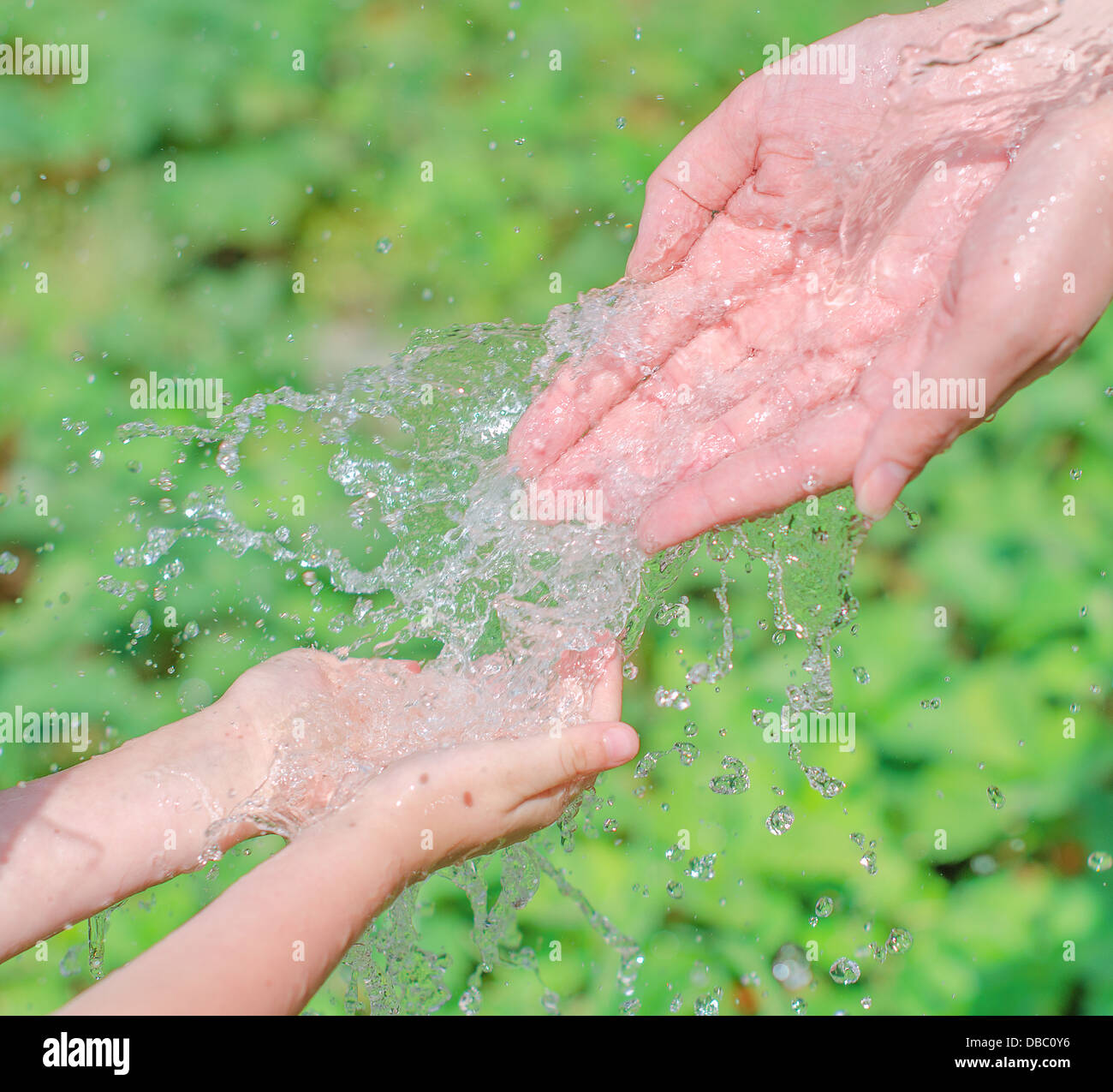 Child's and woman's hands playing with water Stock Photo - Alamy
