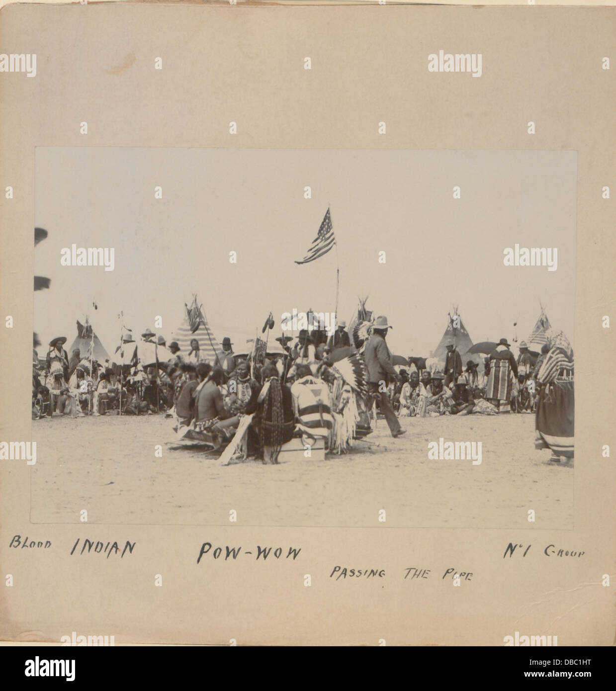 This image shows a group of Blood Indians during a pow-wow, passing the ...