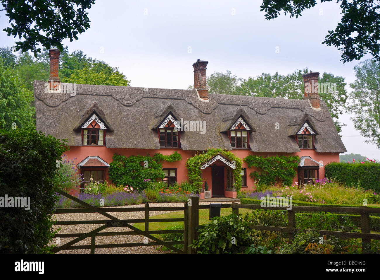 Large Red thatched country cottage Stock Photo - Alamy