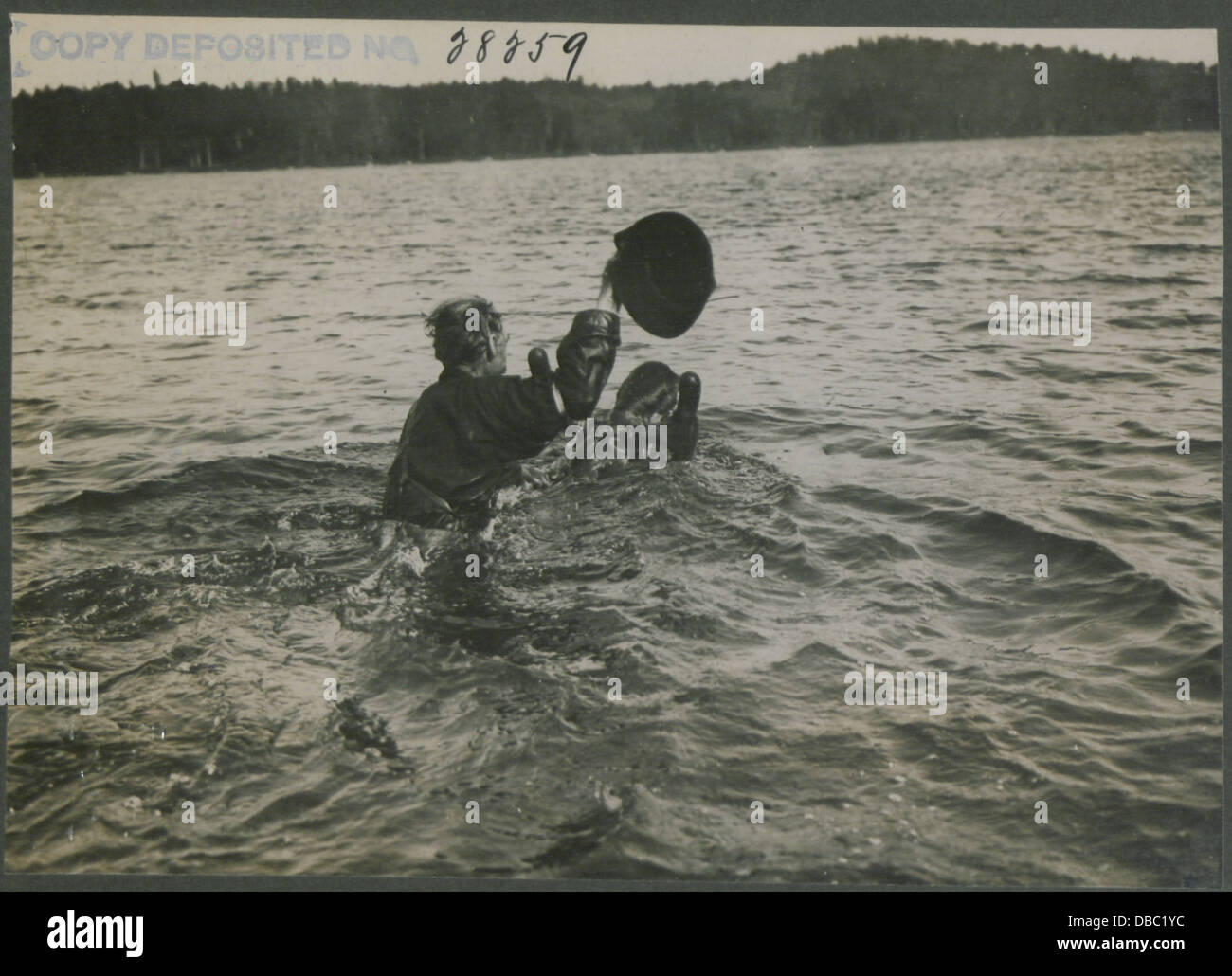 This photograph captures the dramatic moment of bronco busting, as a ...