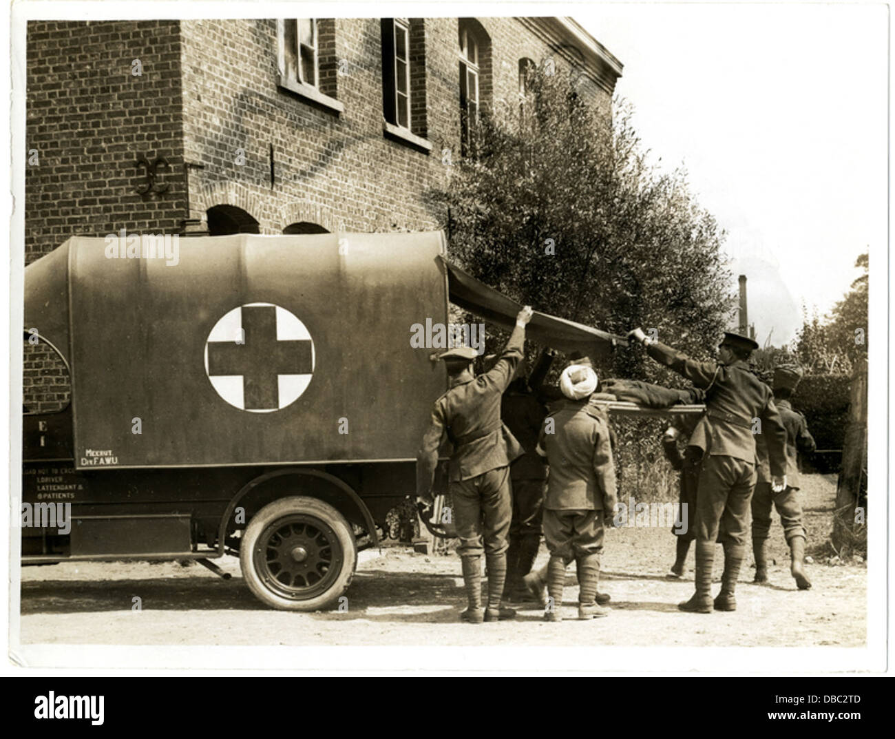This photograph shows a casualty being transported to a field ambulance ...