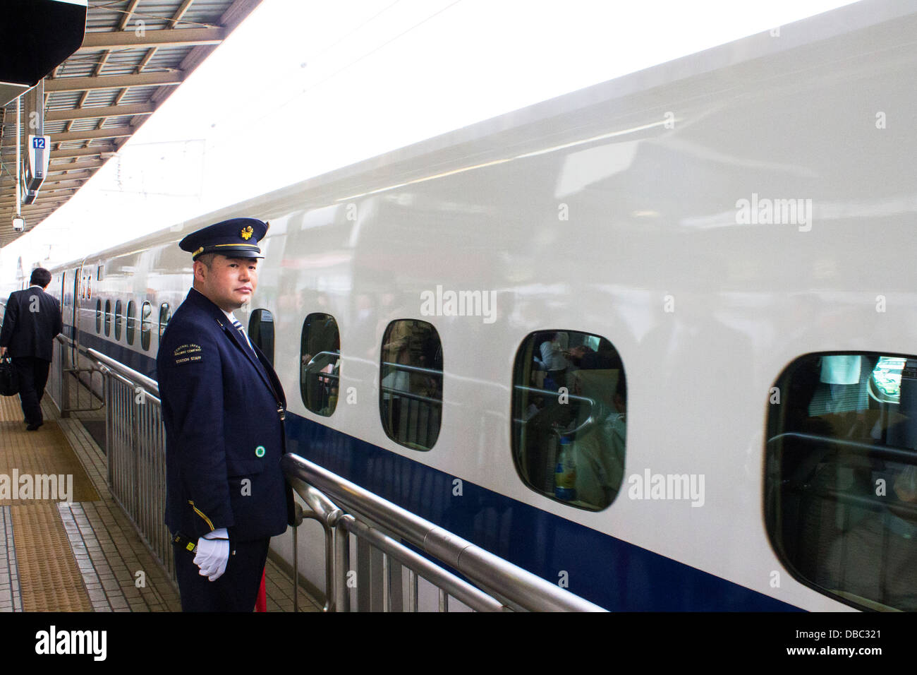 Train Signal Operator signalling Shinkansen Train at Shin-Yokohama ...