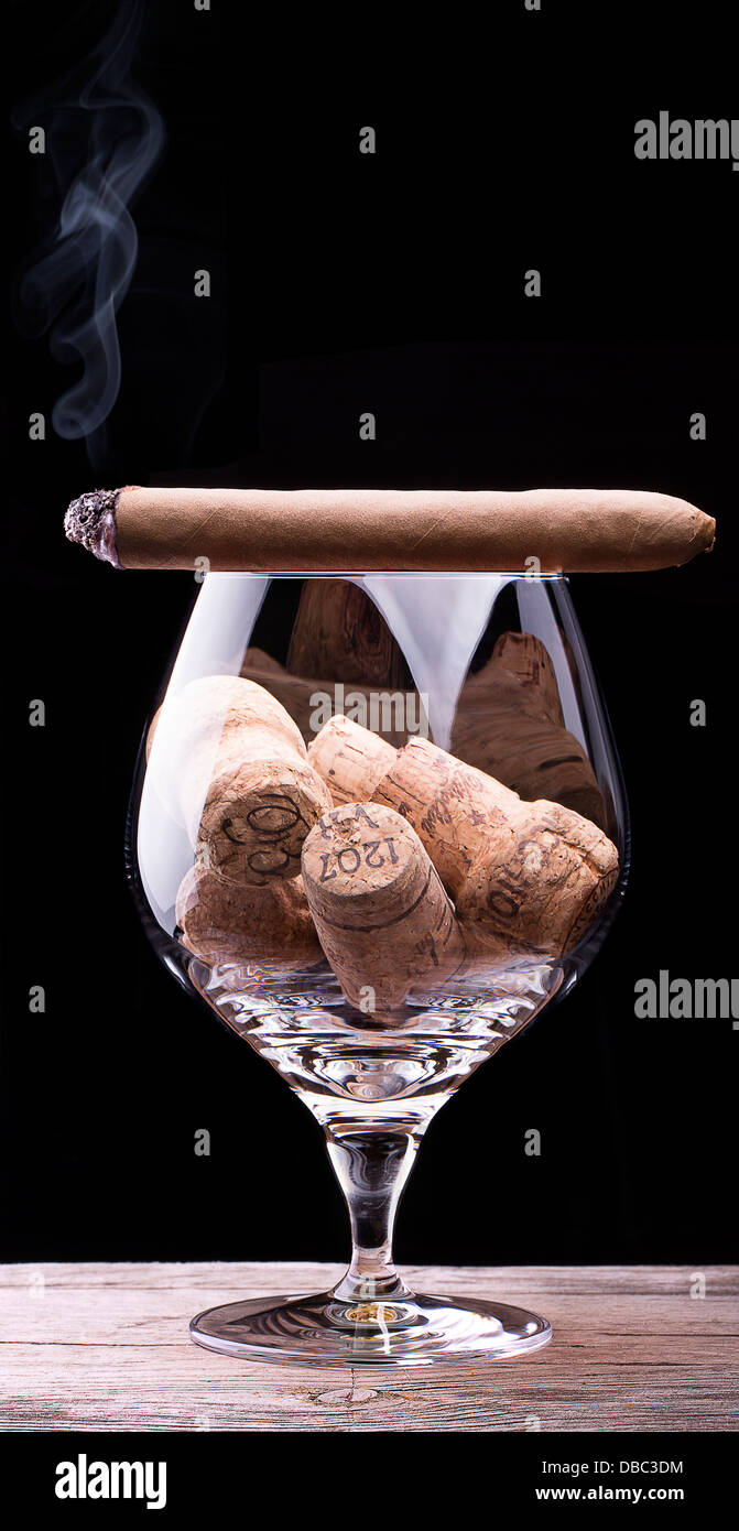 corks in Cognac glass and Cigar on black background Stock Photo - Alamy