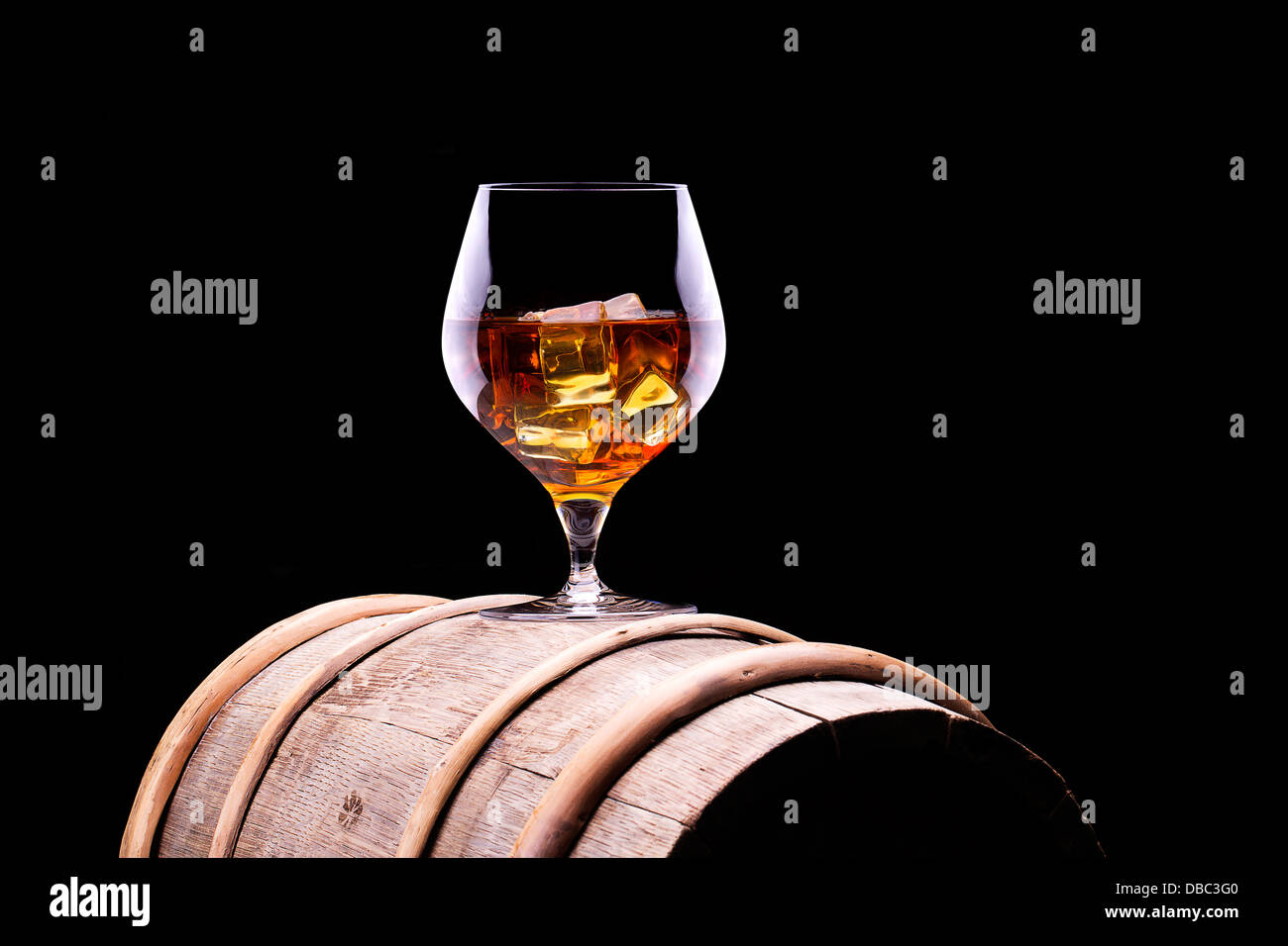 Cognac or brandy on a wooden vintage barrel with black background Stock ...
