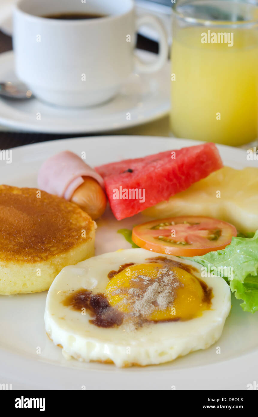 full meal for breakfast ( pancake , fried egg , ham and sausage , fresh ...