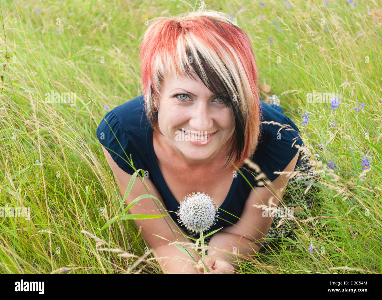 Beautiful girl lying on the grass Stock Photo - Alamy
