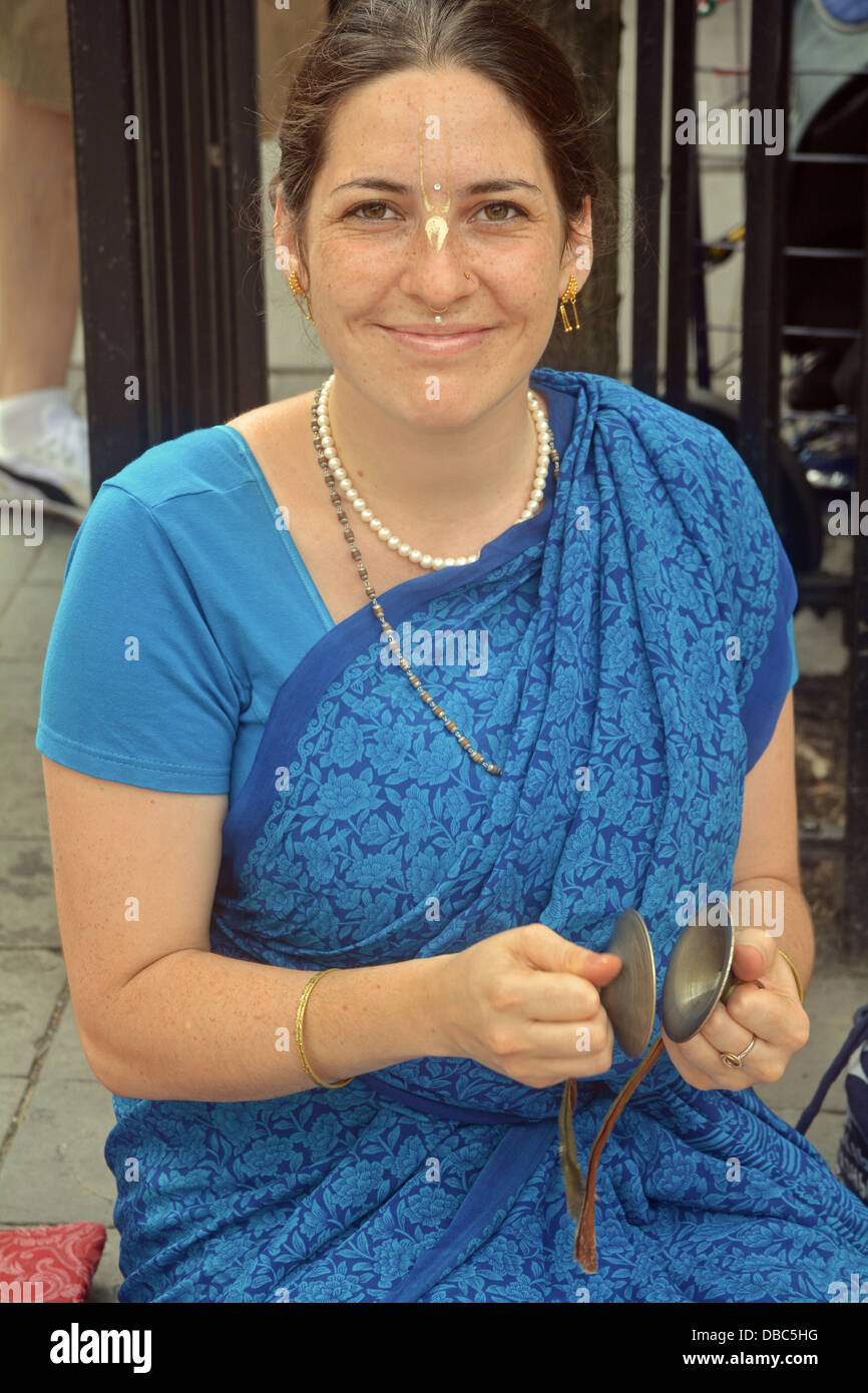 A smiling Hare Krishna street performer playing cymbals in Union Square ...