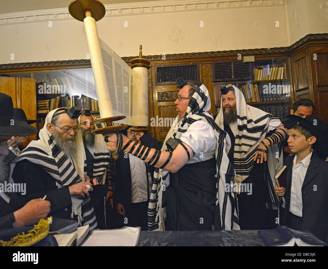 Thursday morning services in the Rebbe's study. The Torah being lifted ...