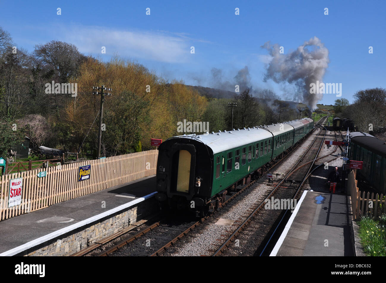 A steam train leaving the station on the Swanage railway Dorset UK ...