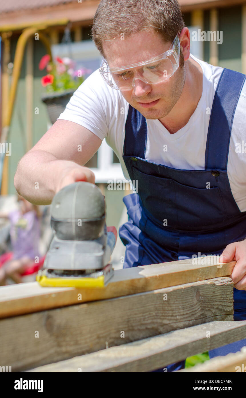 Handyman using polish machine outdoors Stock Photo - Alamy
