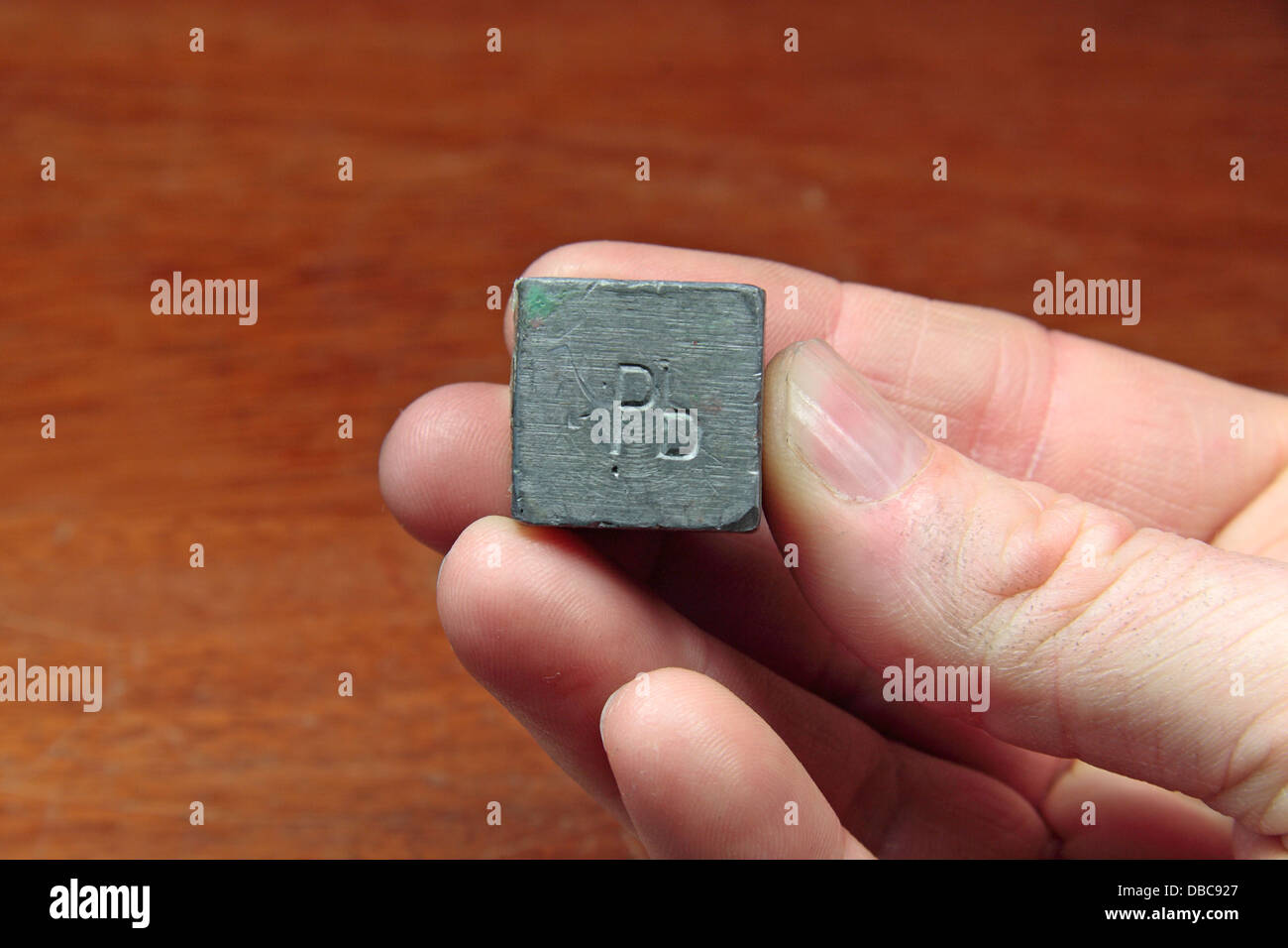 A small block of lead (Pb) with engraved abbreviation, as used in a UK ...