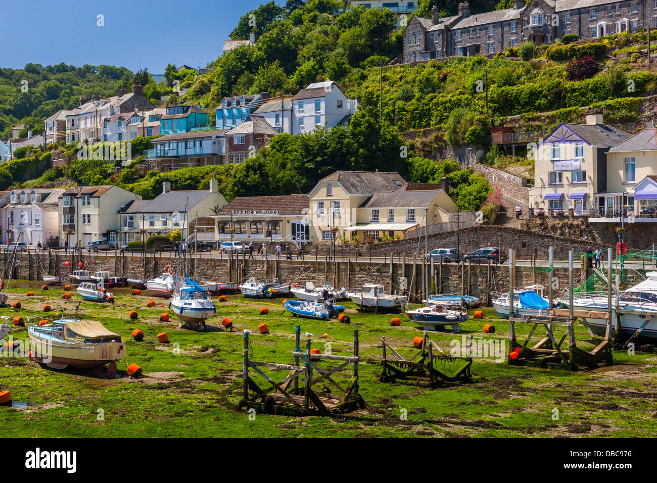 Fishing boats and sailing yachts moored in Looe harbour during low tide ...