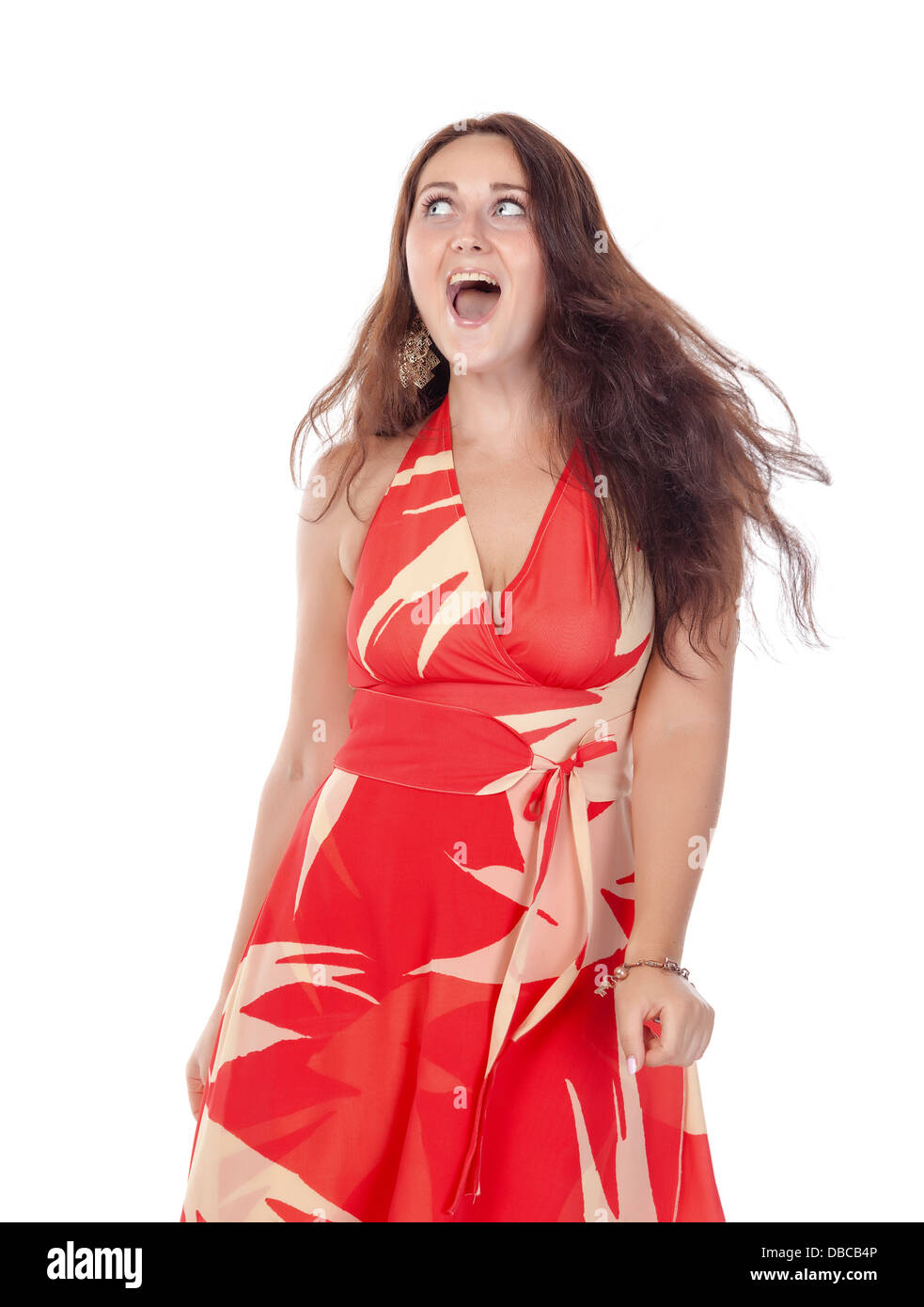 Portrait of a smiling young woman in red dress on white background ...