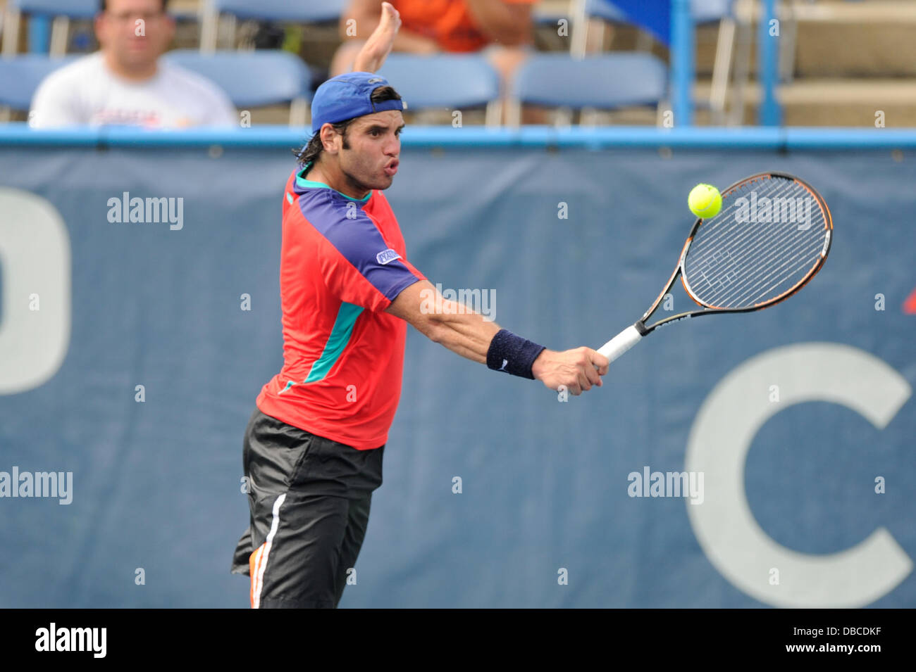 Washington DC, USA. July 28, 2013 - Malek Jaziri (TUN) volleys with ...