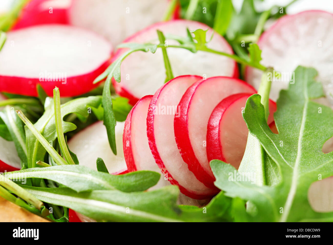Rocket salad with sliced radish Stock Photo - Alamy