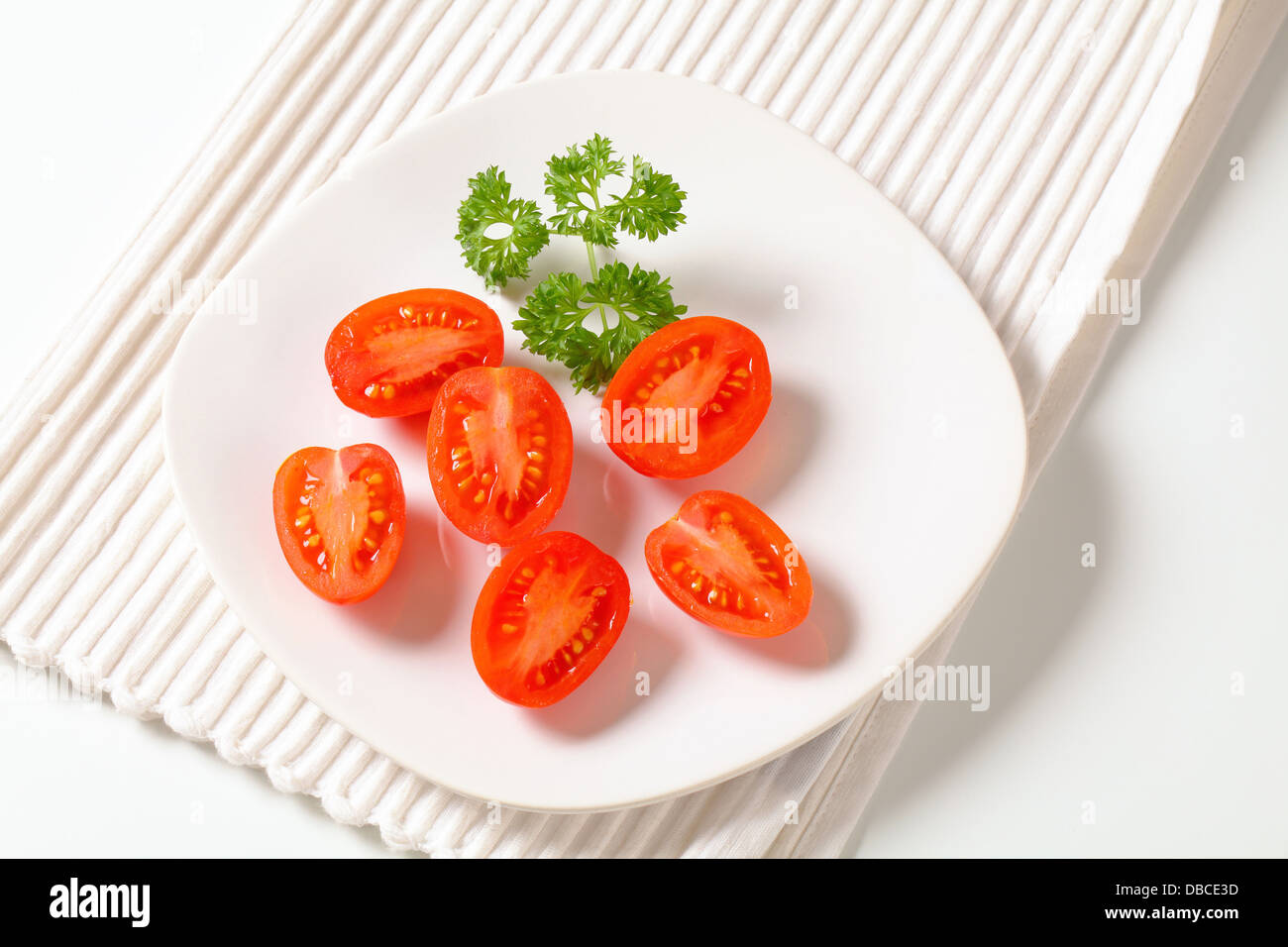 Red plum tomatoes cut into halves Stock Photo - Alamy