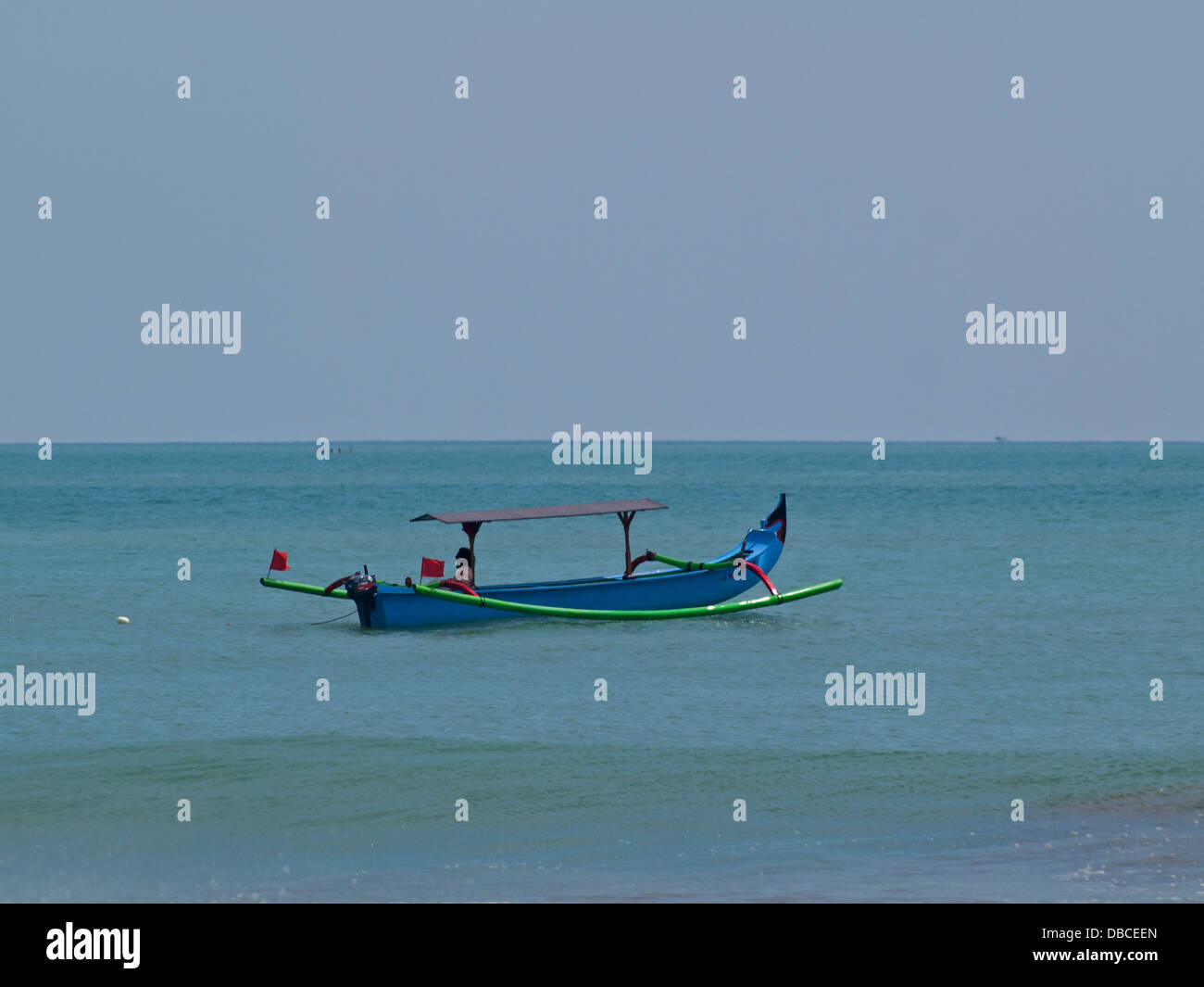 Traditional fishing boat in the sea, Kuta beach Stock Photo - Alamy