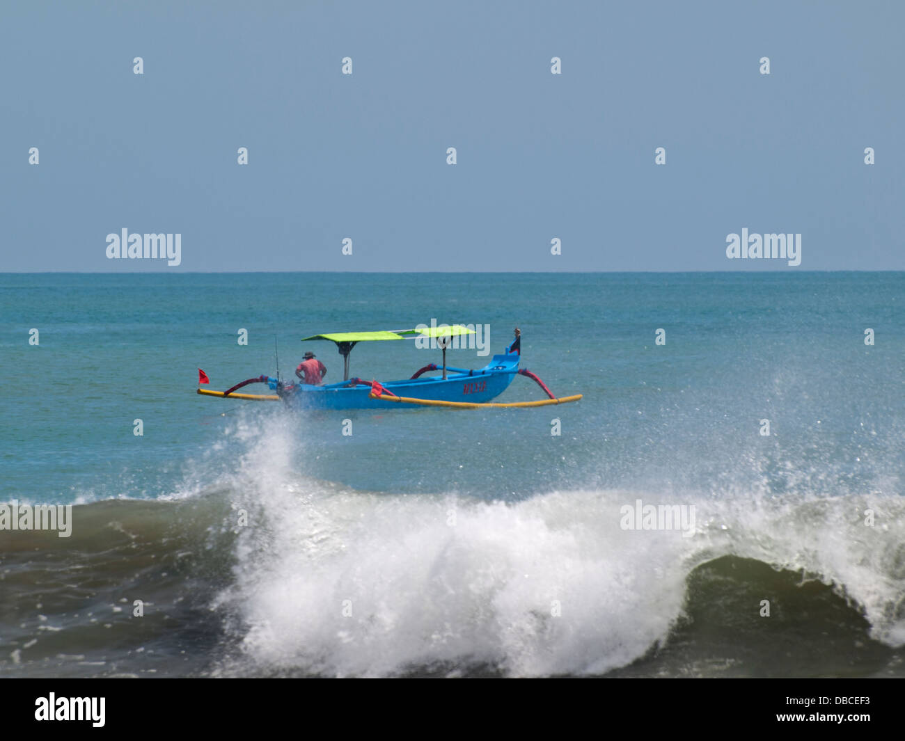 Fishing boat in the sea with crashinh wave, Kuta beach Stock Photo - Alamy