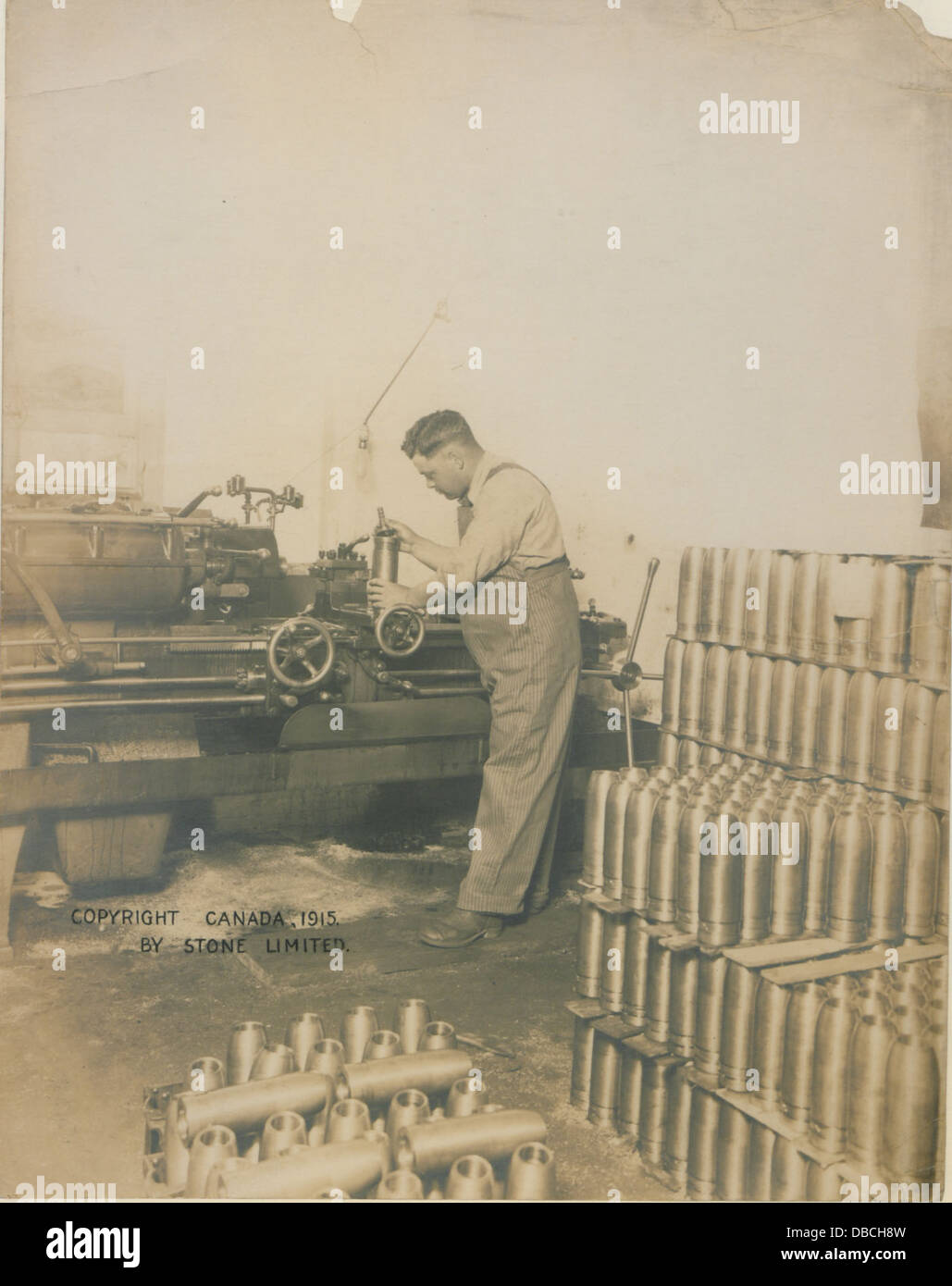 This photograph shows a man in overalls working in a factory, making ...