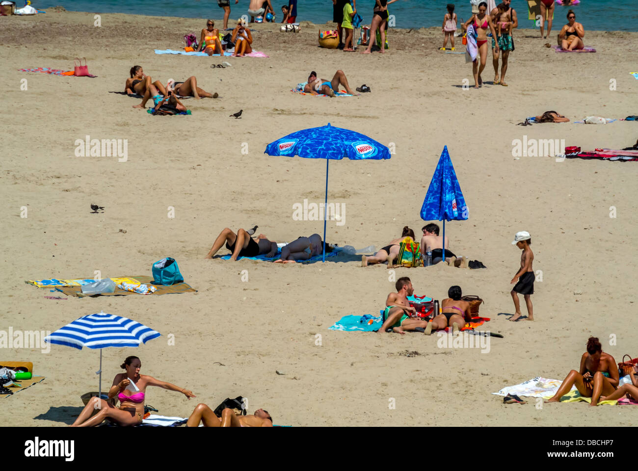 People Relaxing On The Beach