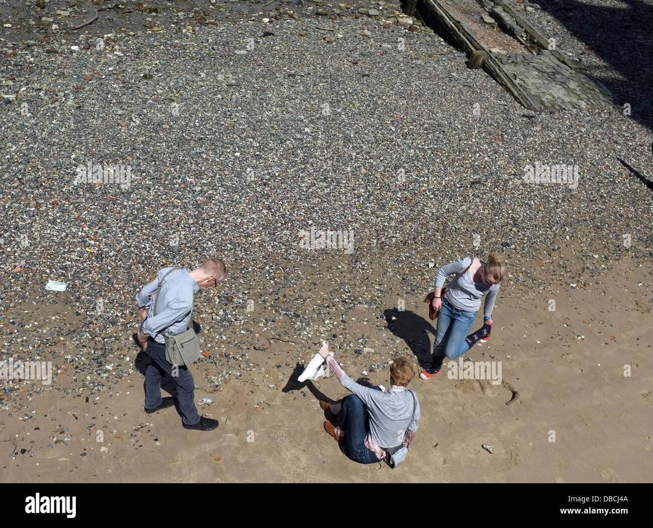 People with clothes on the beach Stock Photo - Alamy