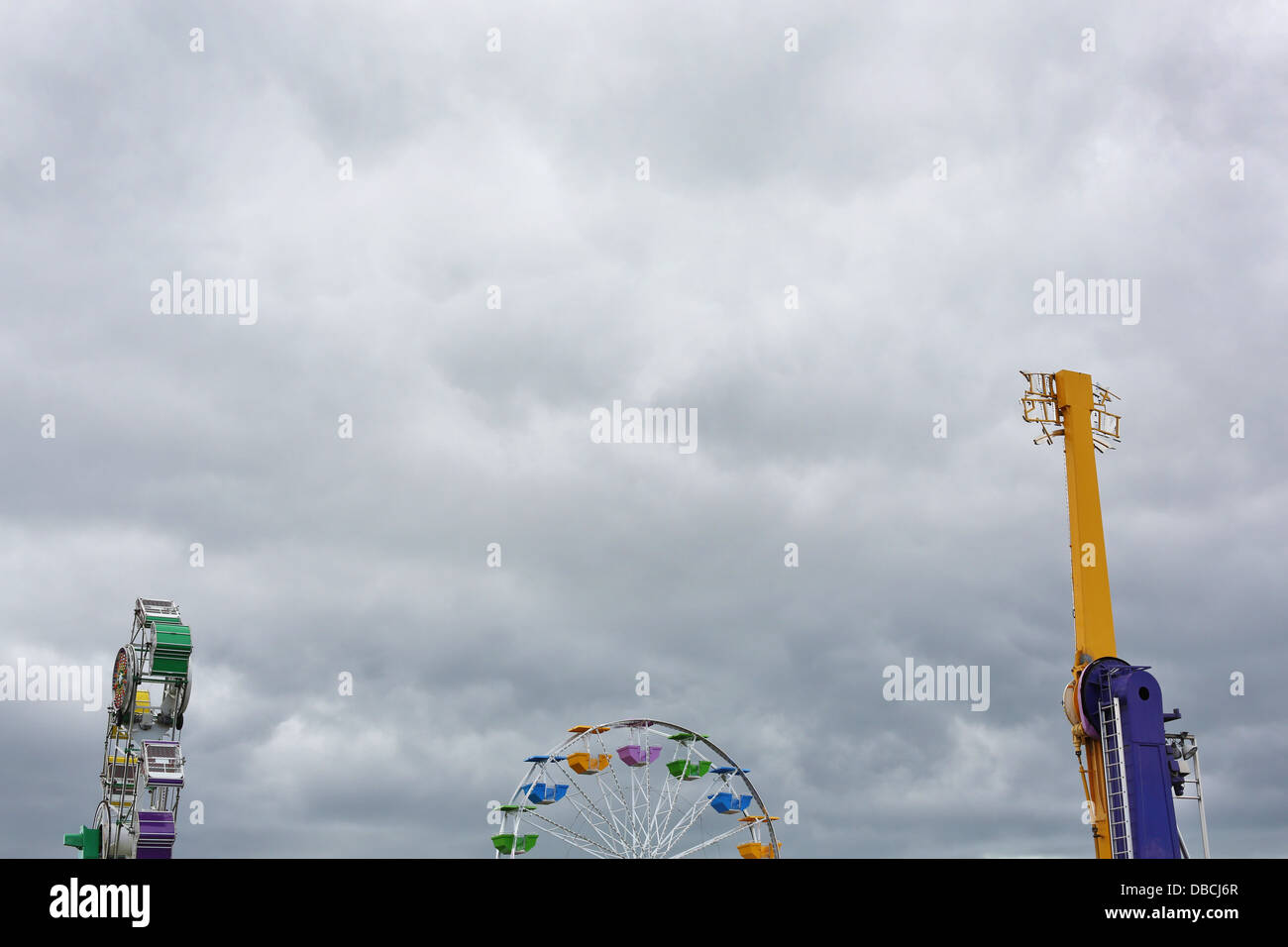 The tops of carnival rides against a dark and cloudy sky Stock Photo ...