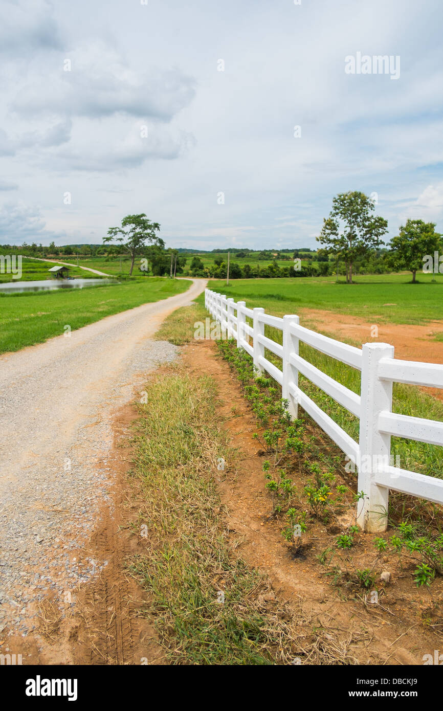 white fence in farm field and overcast sky Stock Photo - Alamy