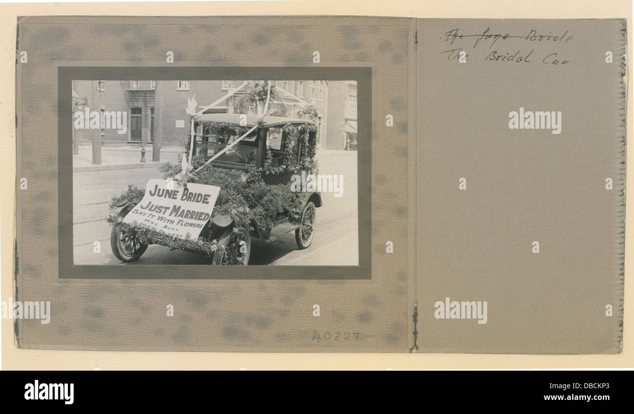This image shows a decorated bridal car, likely from the early 20th ...