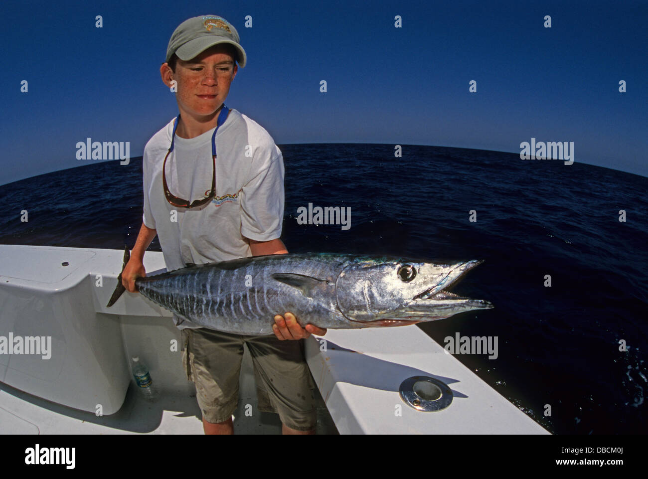 Young boy with a wahoo (Acanthocybium solandri) caught while fishing at ...