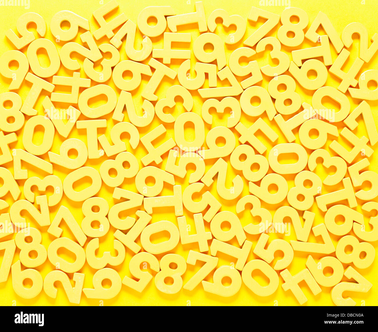 Yellow Plastic Numbers On Yellow Background Stock Photo - Alamy