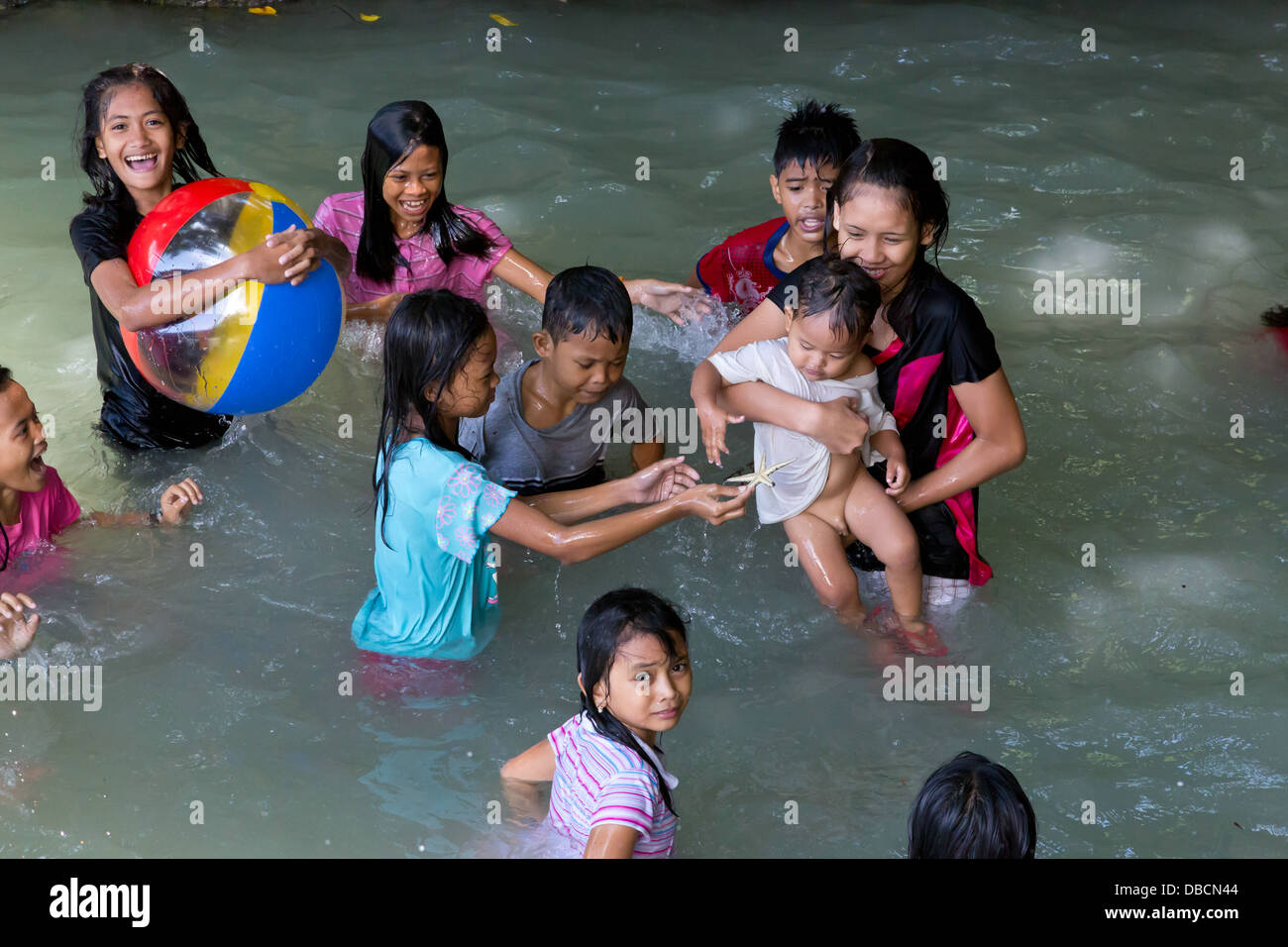 Young local Children enjoying a Bath in a Pool in Tagbilaran on Bohol ...
