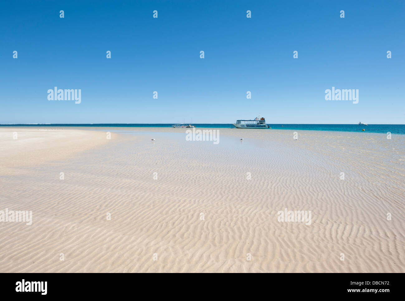 The white beach and turquoise waters of Coral Bay, a popular holiday ...