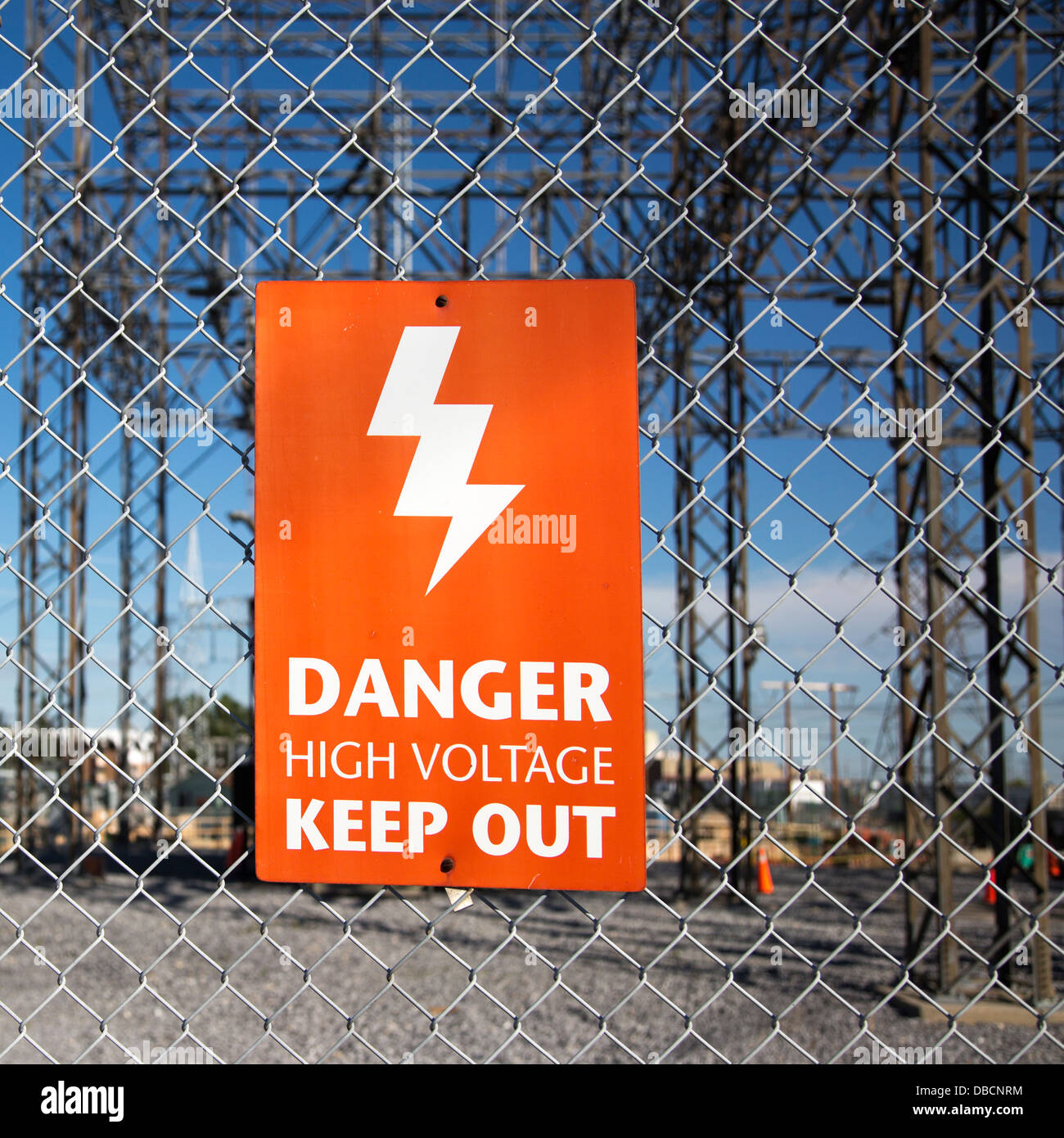Danger - keep out sign on fence surrounding electrical substation Stock ...