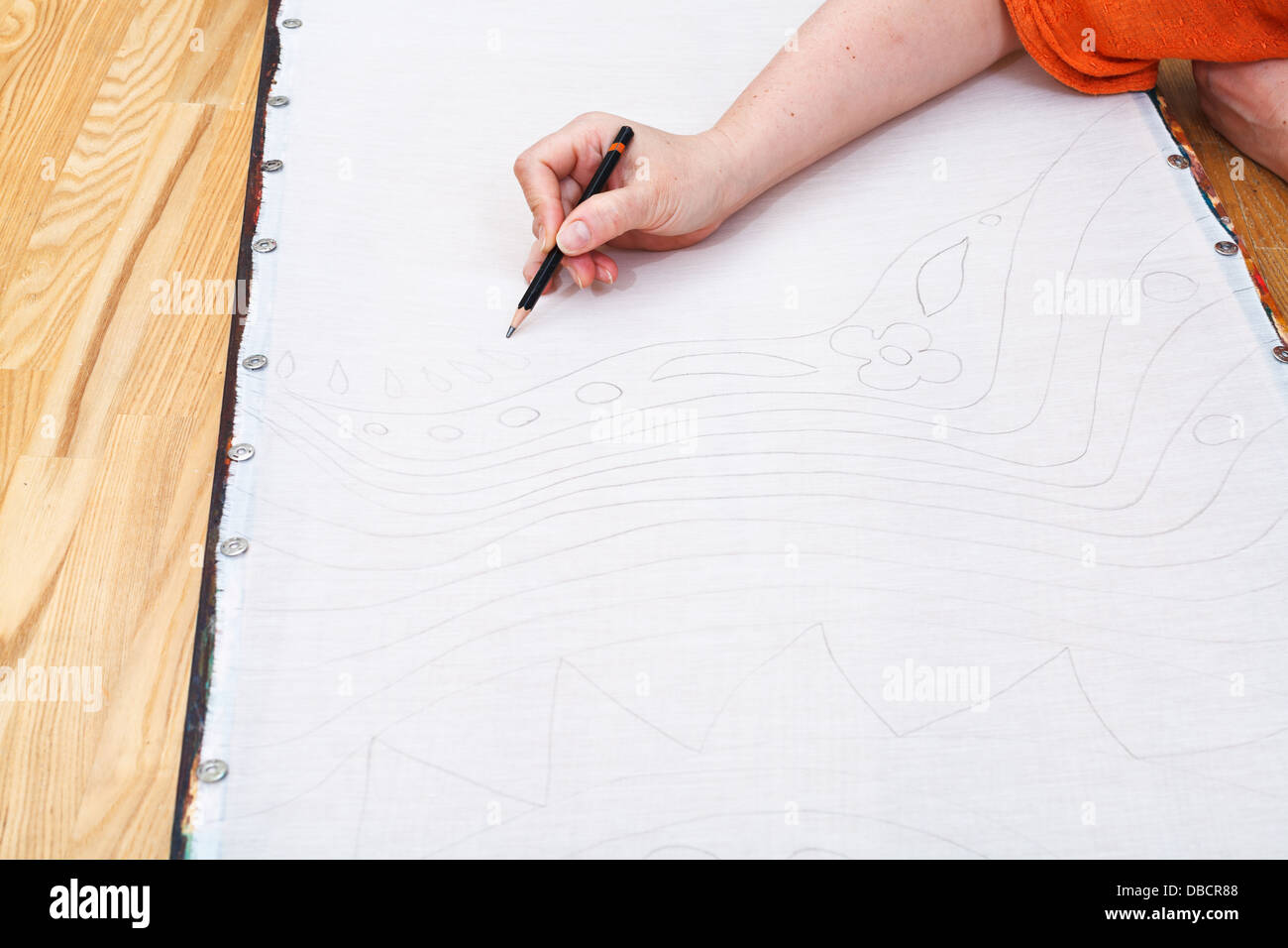 artist draws pencil pattern on silk for cold batik painting Stock Photo ...