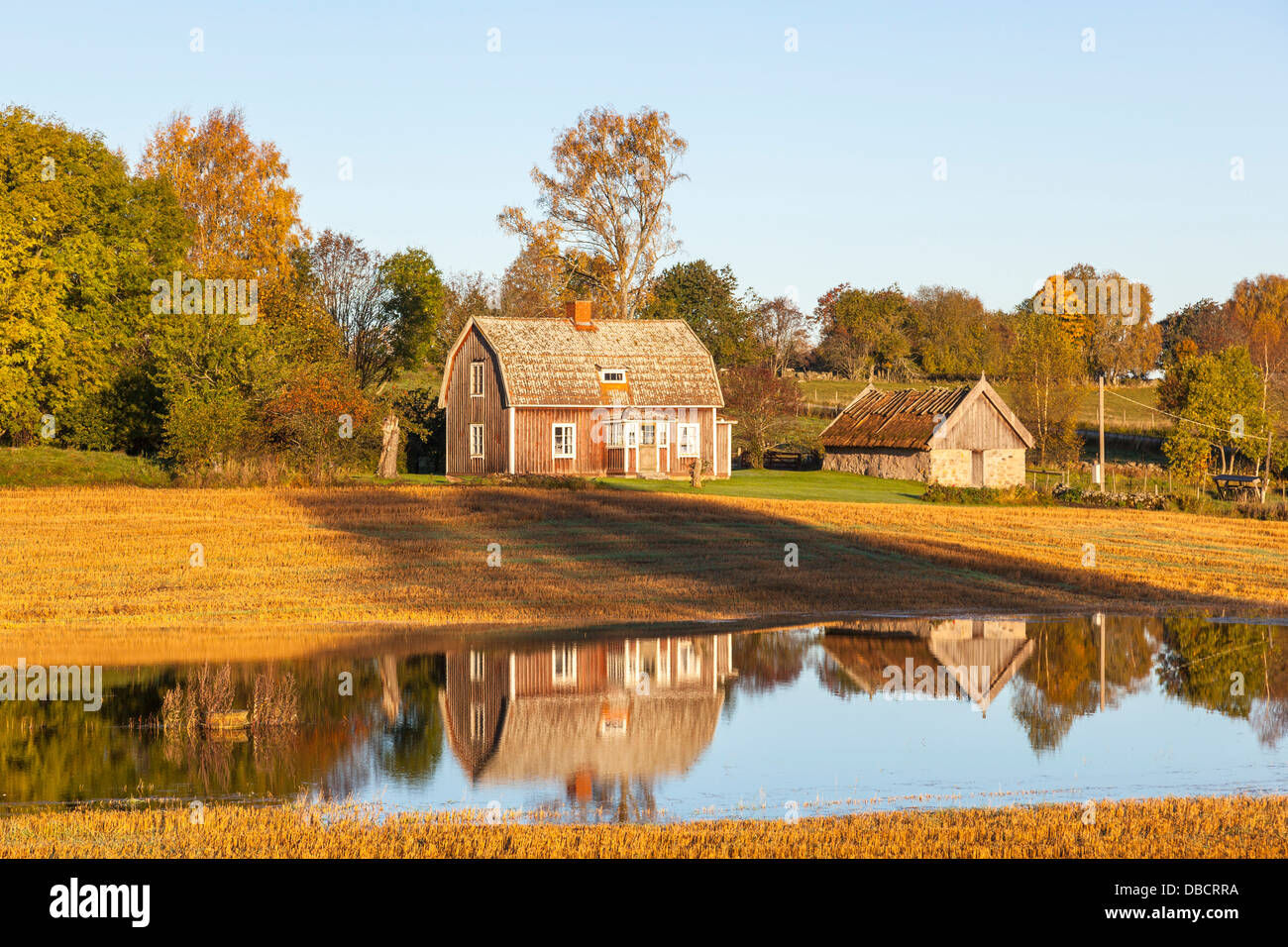 Old aged red cottage in the field Stock Photo - Alamy