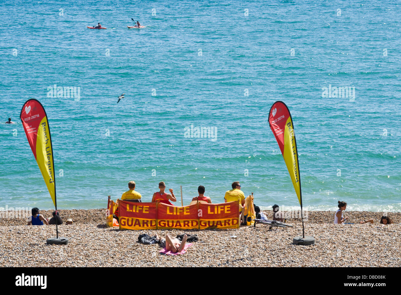 Lifeguards keep watch over holidaymakers on the beach at Brighton East ...